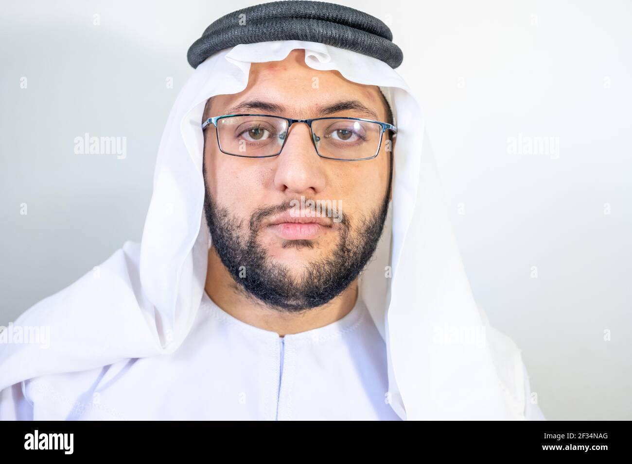 Arabic Muslim man at work holding his eyeglasses Stock Photo - Alamy