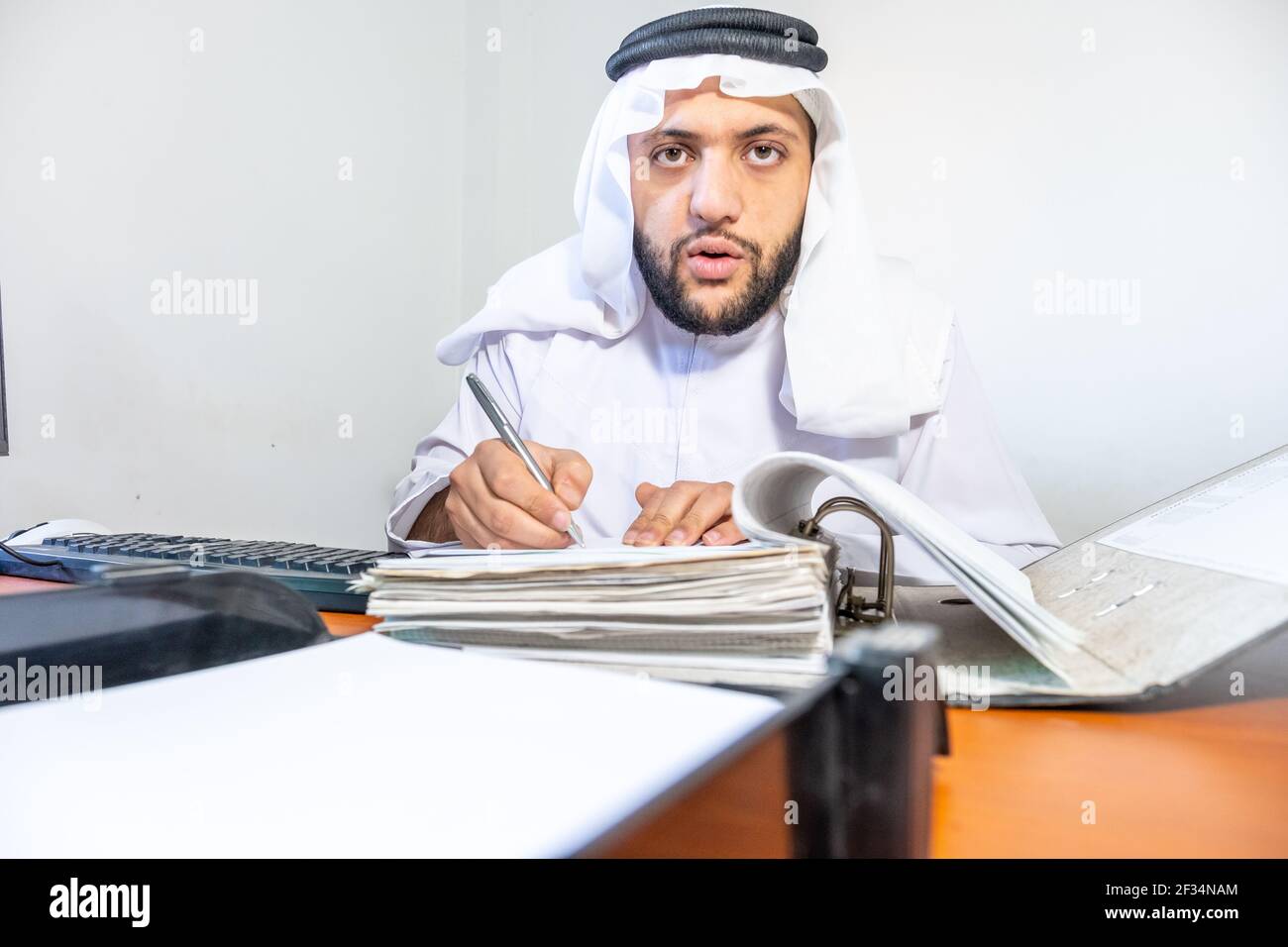 Arabic Muslim man feeling tired at work Stock Photo - Alamy