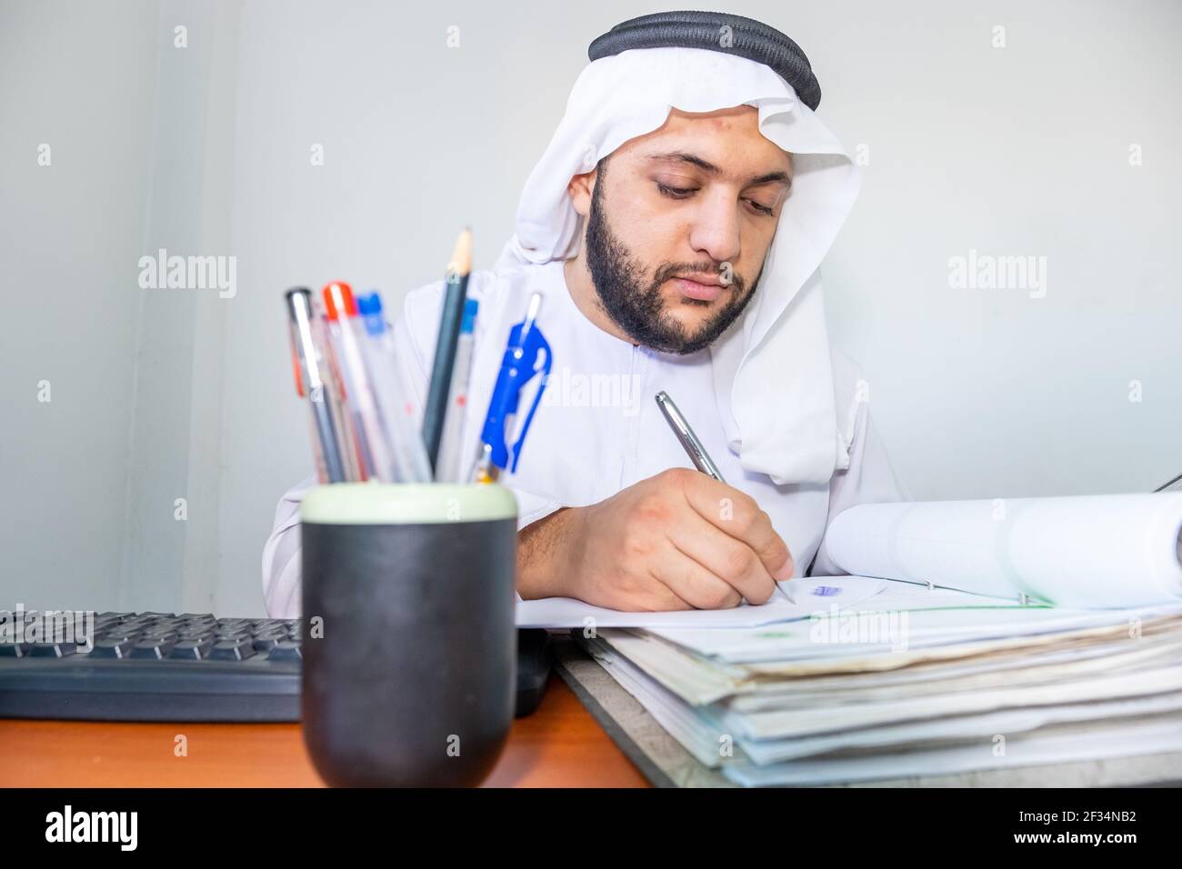Arabic Muslim man working on some paper Stock Photo - Alamy