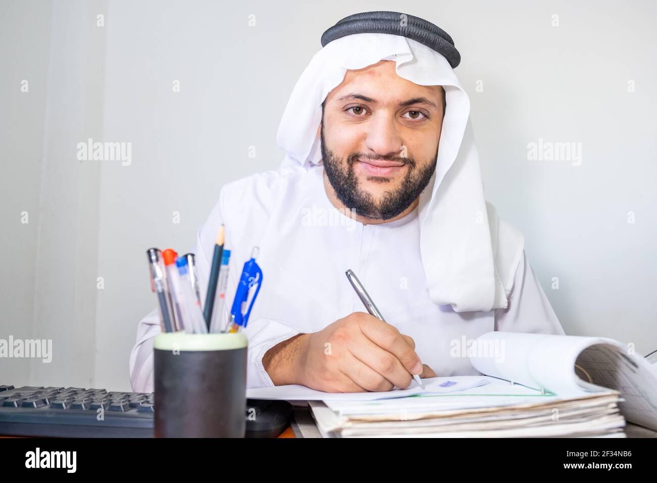 Arabic Muslim man working on some paper Stock Photo - Alamy
