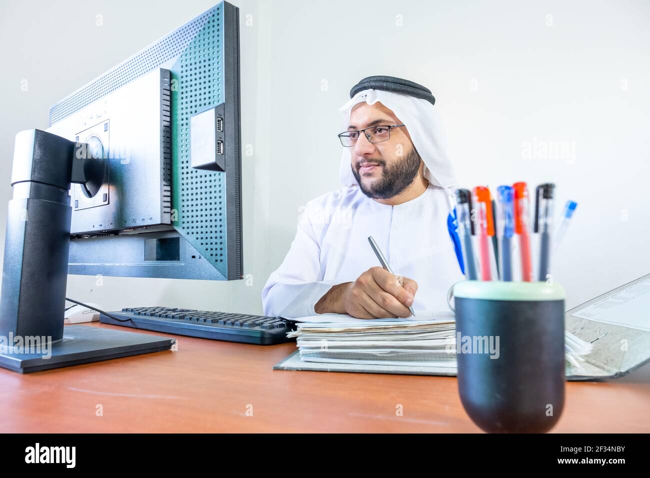 Arabic Muslim man working on some paper Stock Photo - Alamy