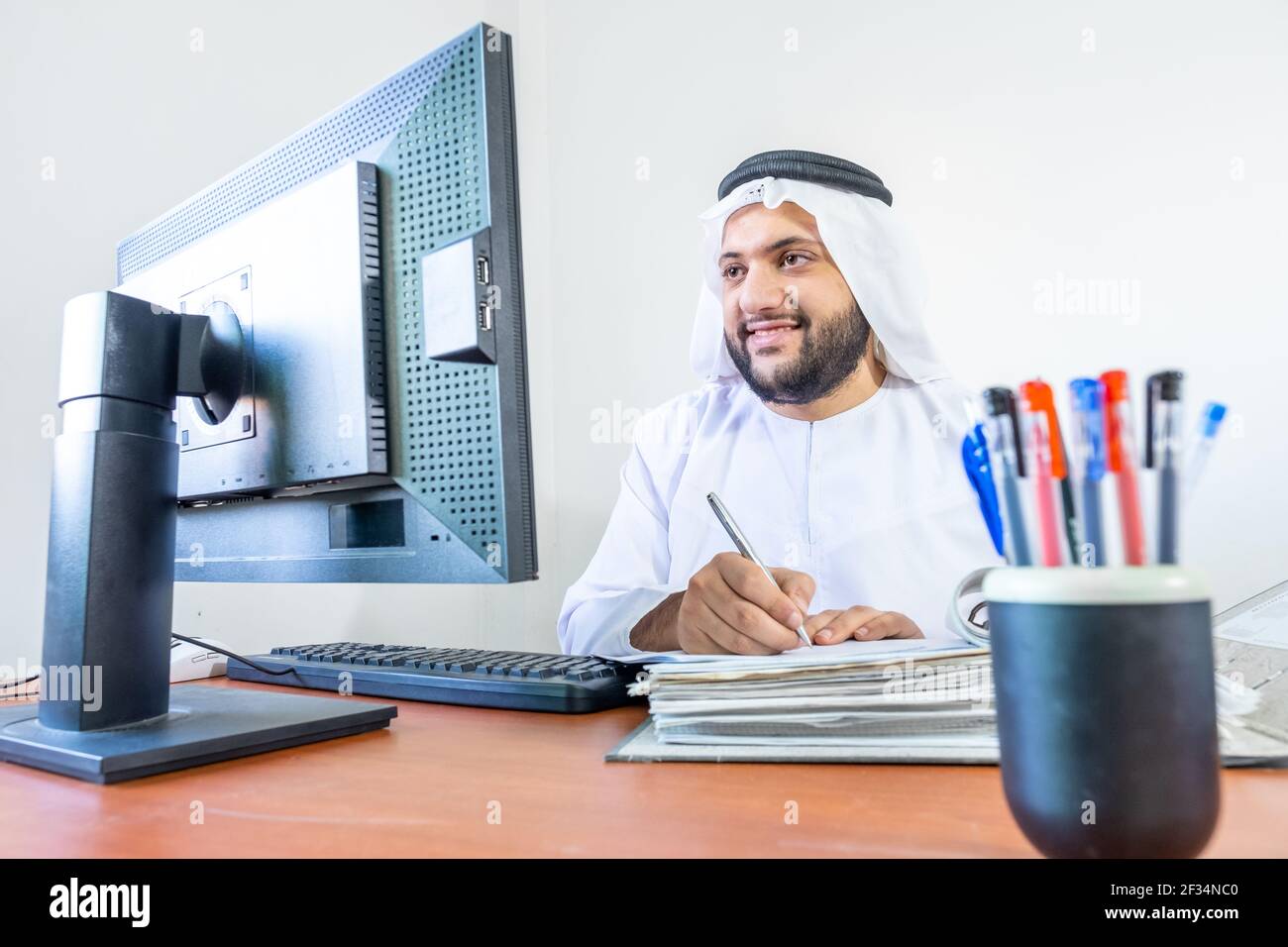 Arabic Muslim man working on some paper Stock Photo - Alamy