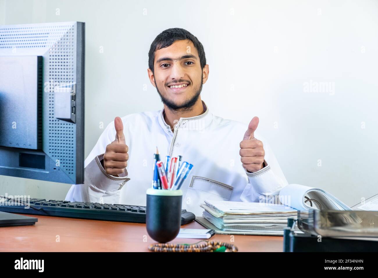 Arabic muslim employee happy at his workplace Stock Photo - Alamy