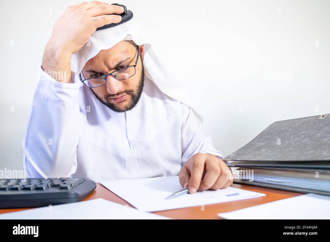 Arabic Muslim feeling stressed at work Stock Photo - Alamy