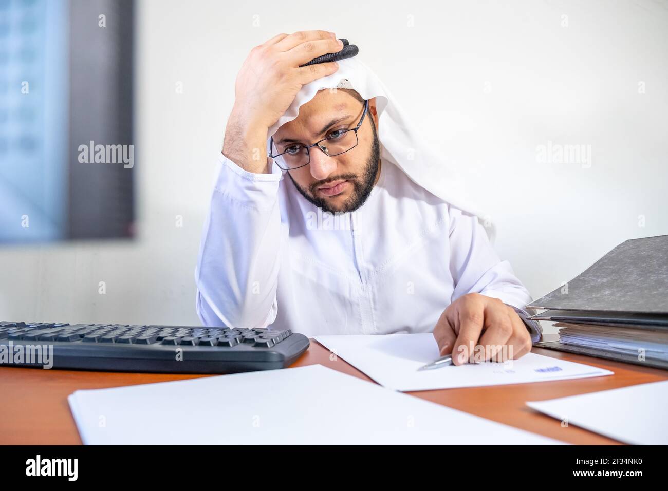 Arabic Muslim feeling stressed at work Stock Photo - Alamy
