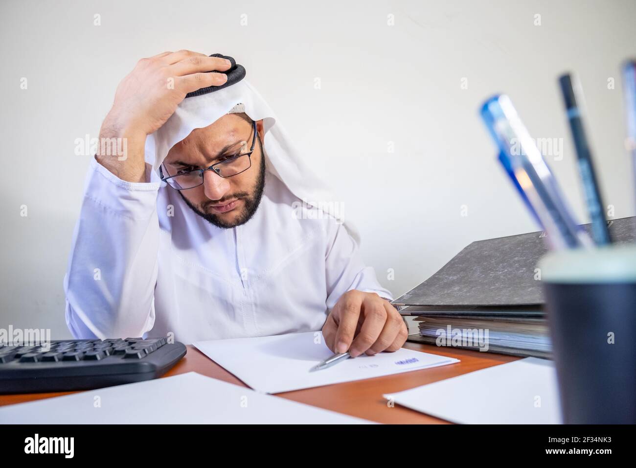 Arabic Muslim feeling stressed at work Stock Photo - Alamy