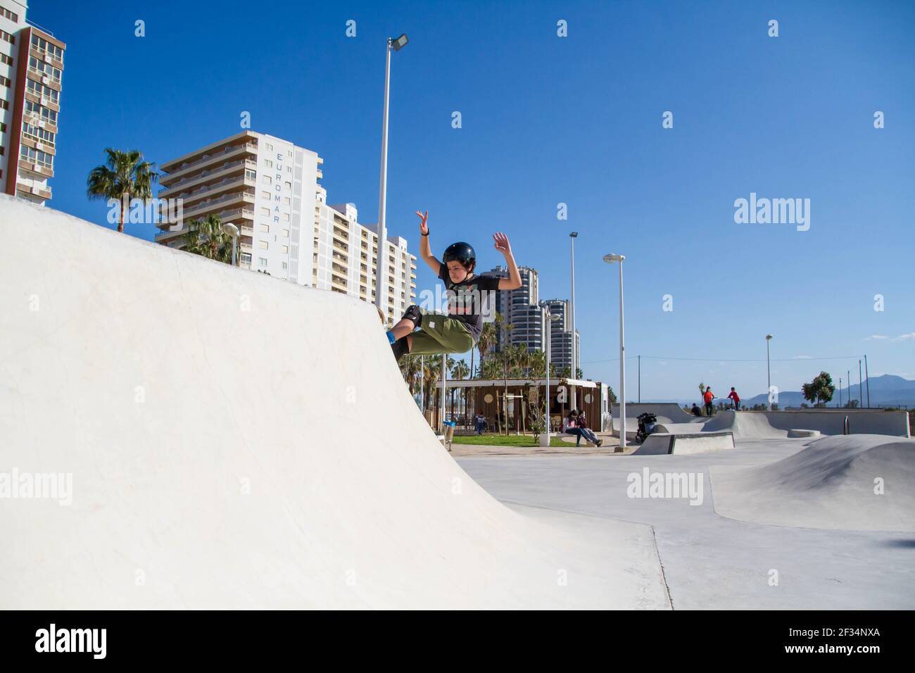Teenage boy in skateboard park against blue sky Stock Photo - Alamy