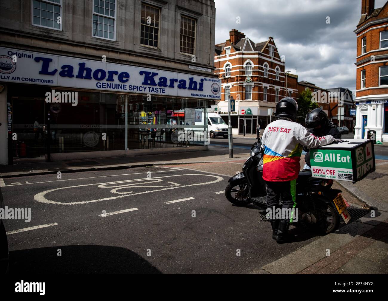 Just Eat drivers wait for a food collection in Tooting, South London ...