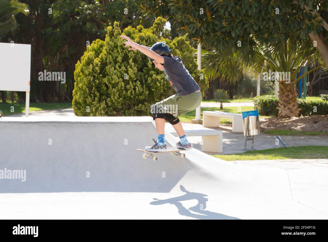 Teenage boy in skateboard park against blue sky Stock Photo - Alamy