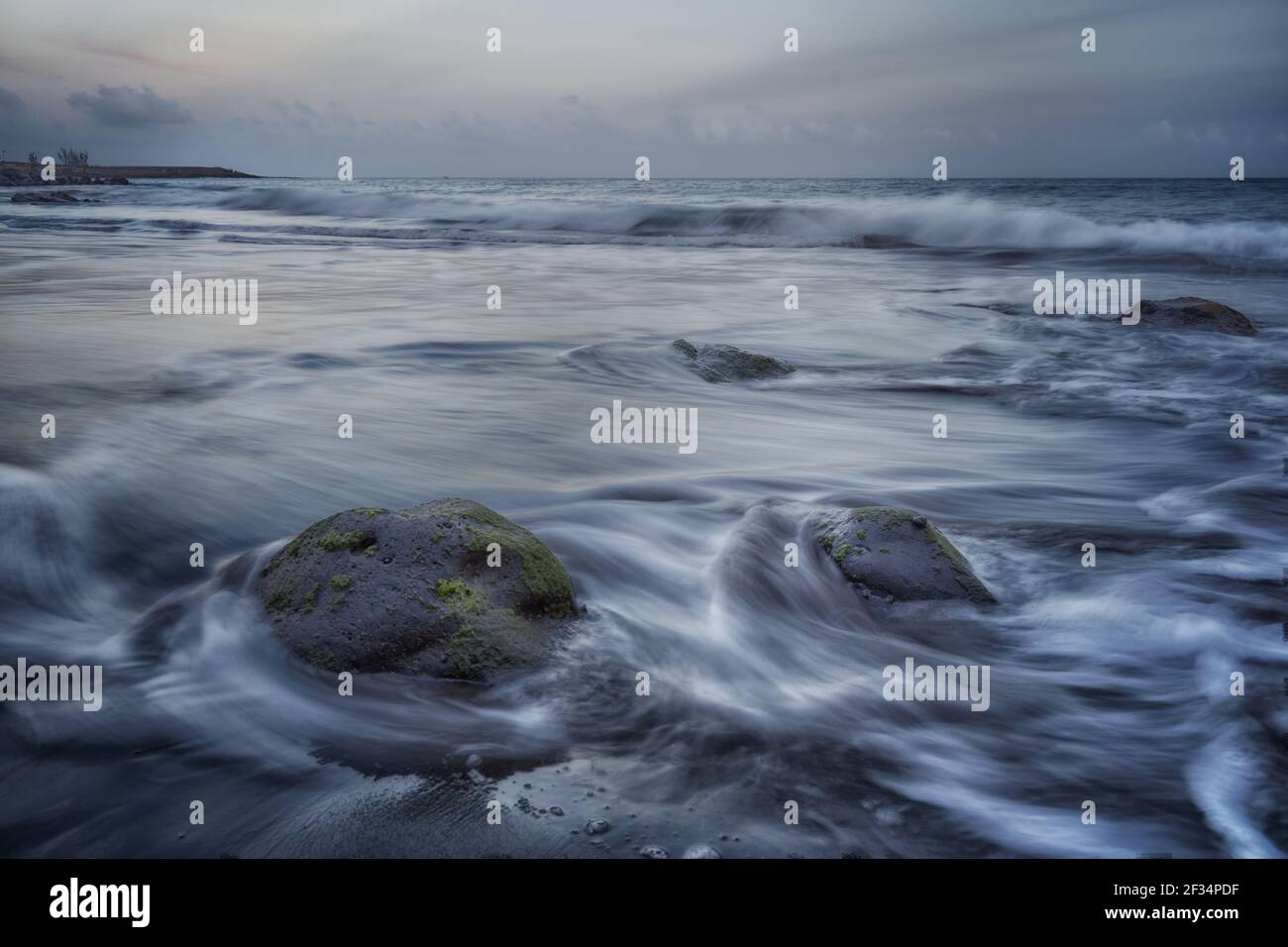 A mesmerizing seascape with wavy water on the gloomy sky background ...