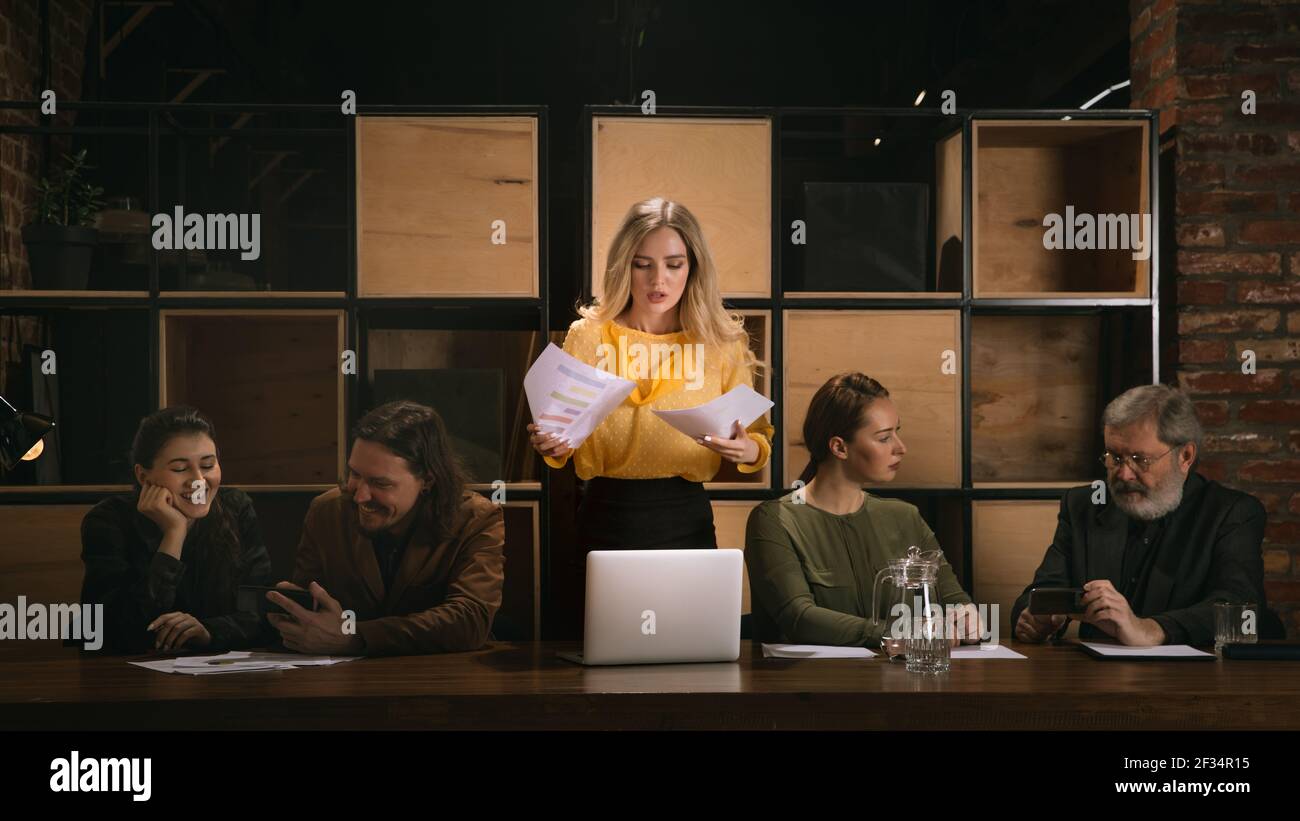 Paperwork. Young colleagues working together in a office styled like ...