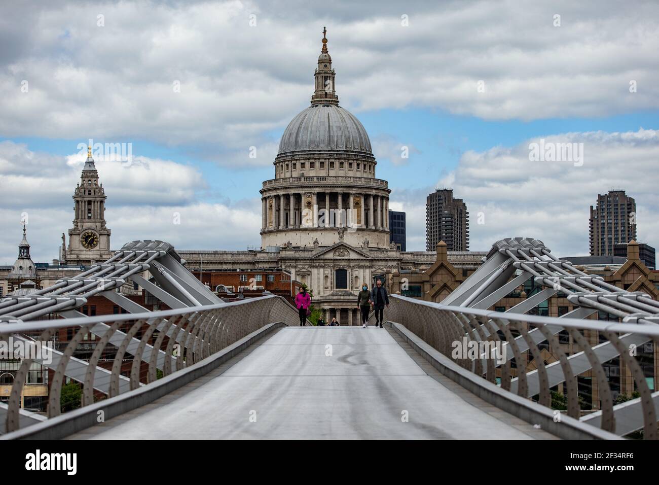 Members of the public walk over Millennium Bridge in Central London ...