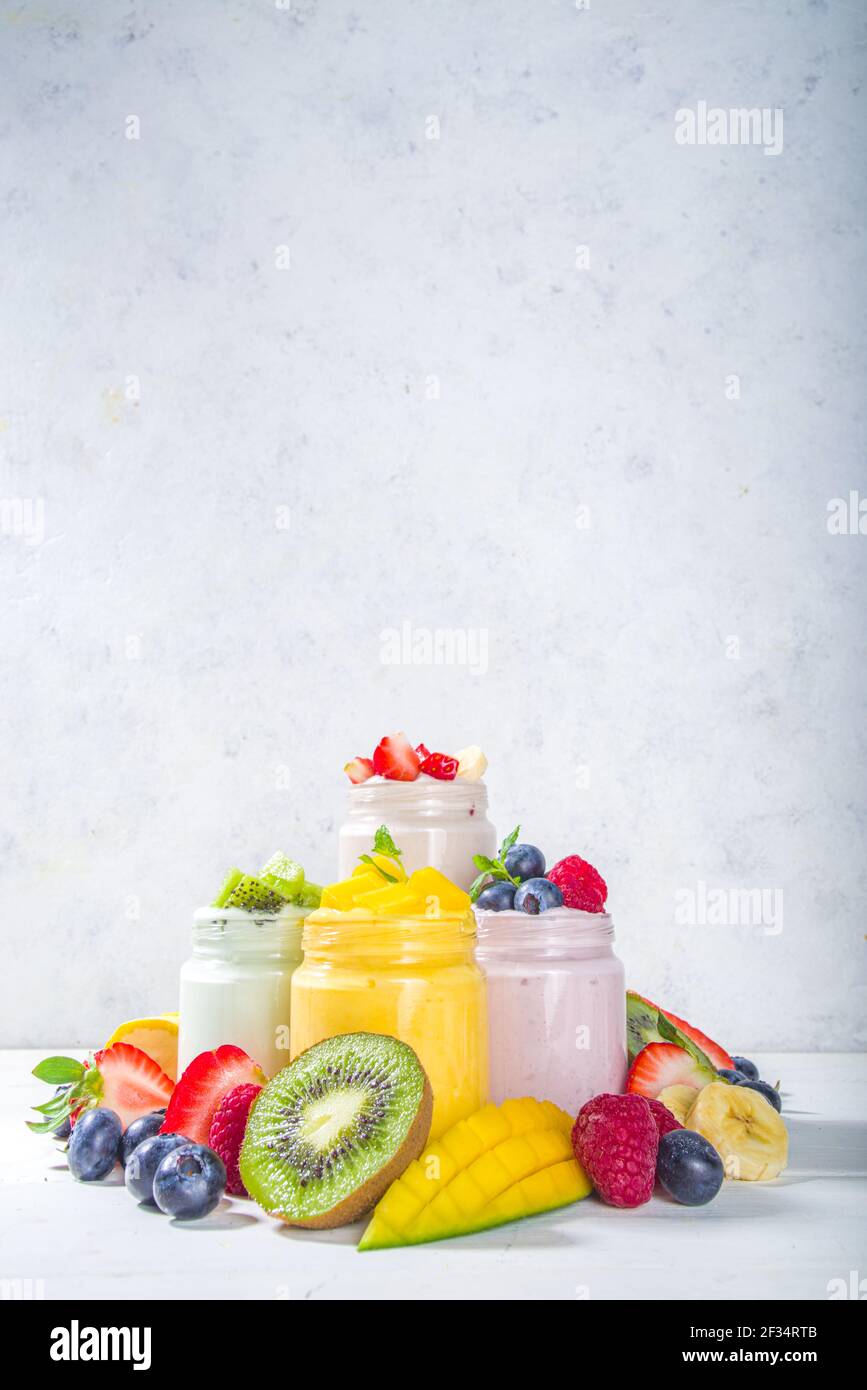 Set of various fruit and berry sweet yogurts in glass jars. Variety ...