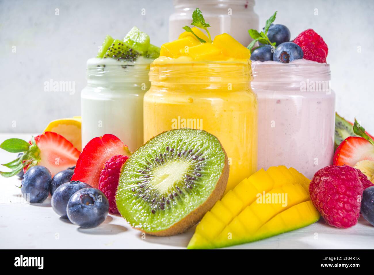 Set of various fruit and berry sweet yogurts in glass jars. Variety ...