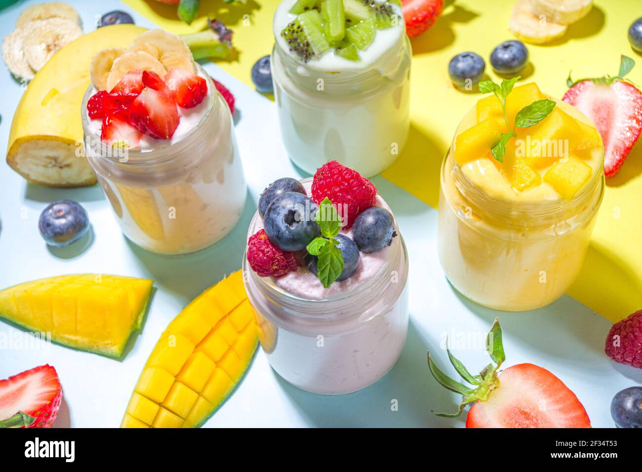 Set of various fruit and berry yogurts in glass jars. Variety healthy ...
