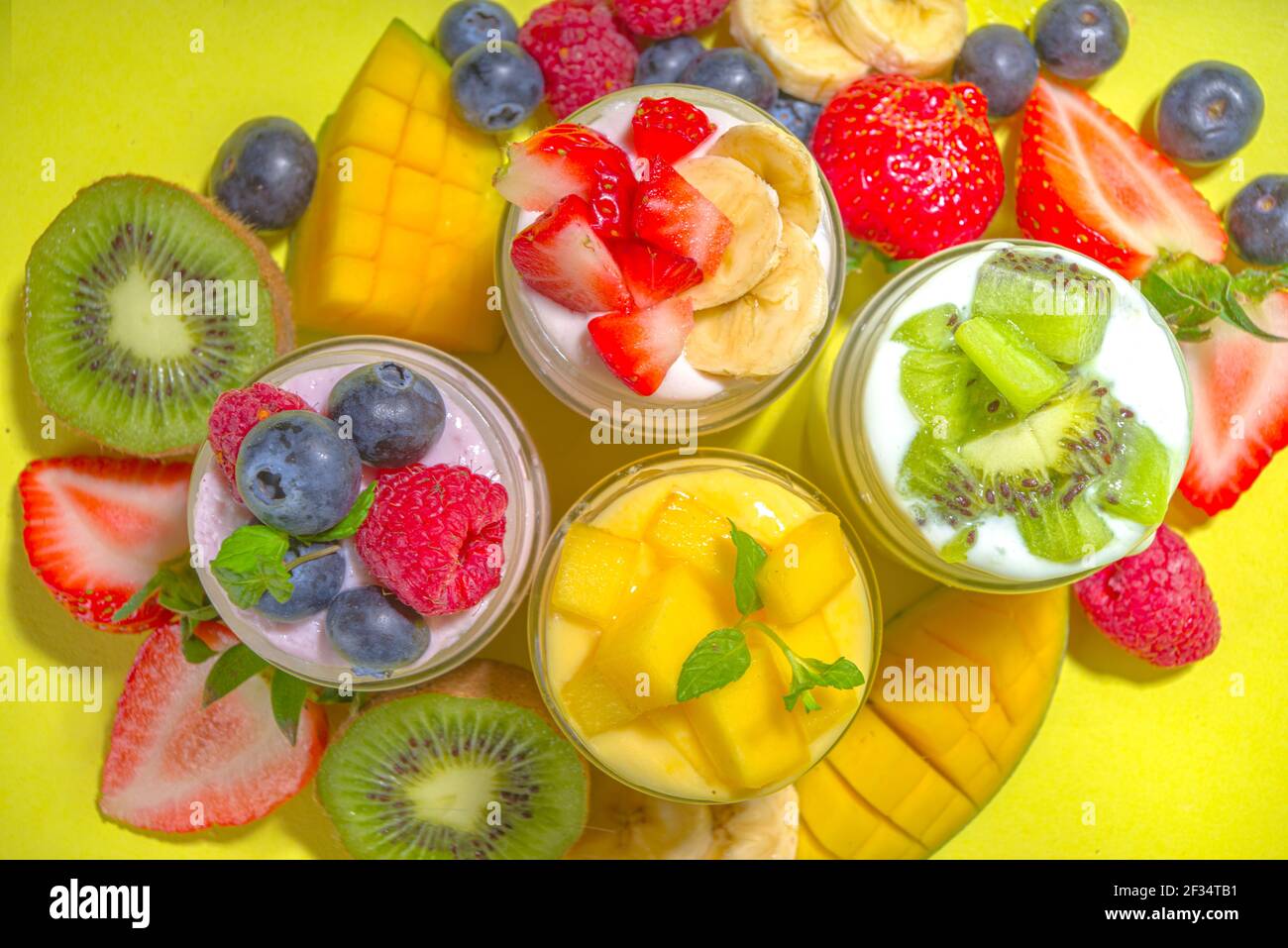 Set of various fruit and berry yogurts in glass jars. Variety healthy ...