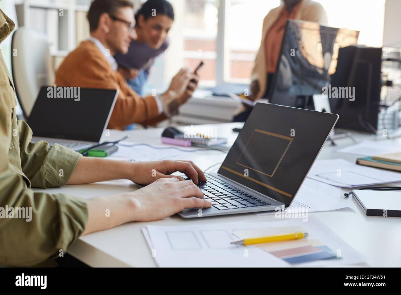 Side view closeup of IT programmer writing code on laptop screen while ...