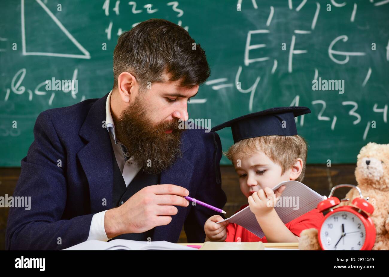 Father with beard, teacher teaches son, little boy. Individual ...