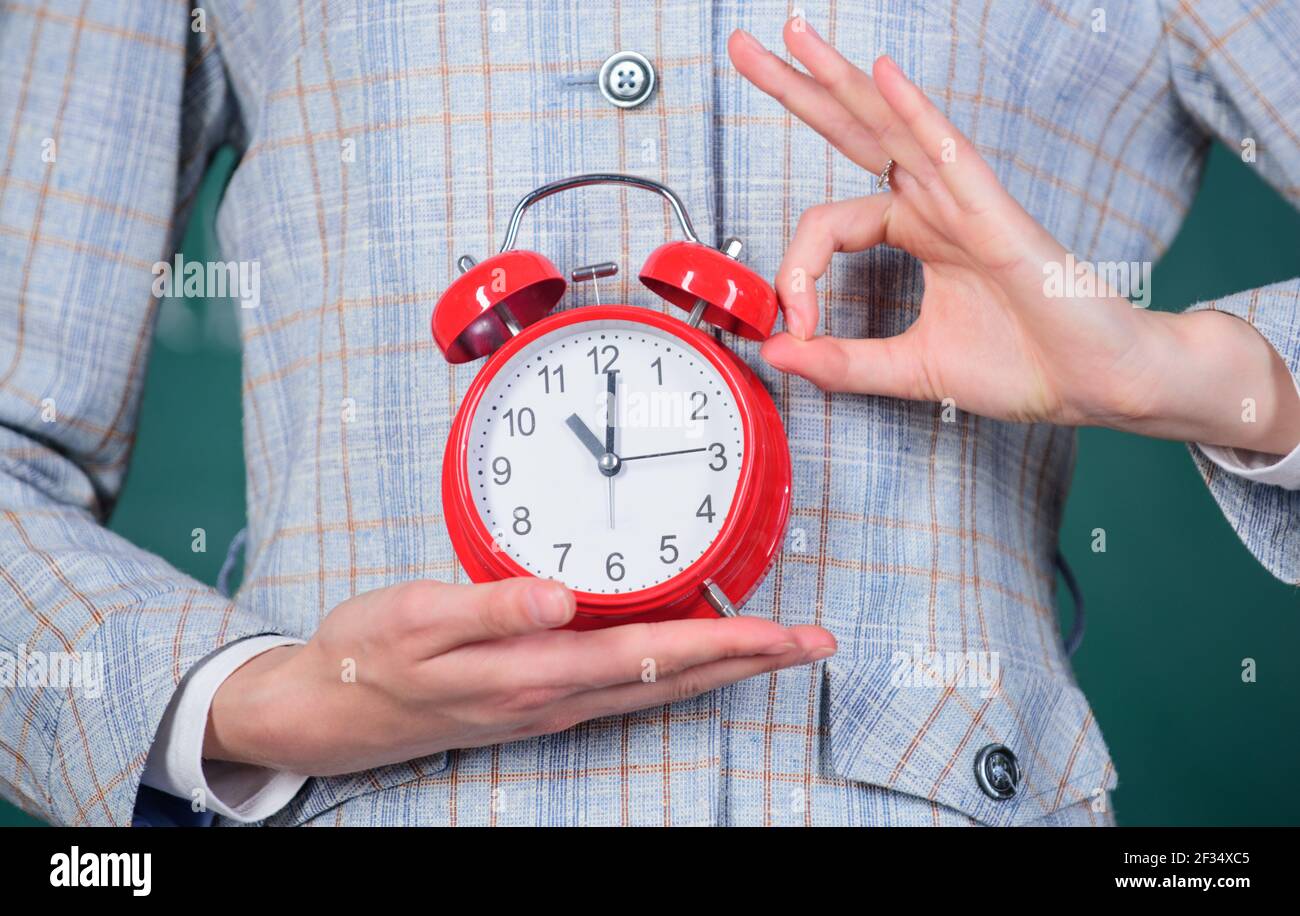 Teachers attributes. Alarm clock in hands of teacher or educator ...