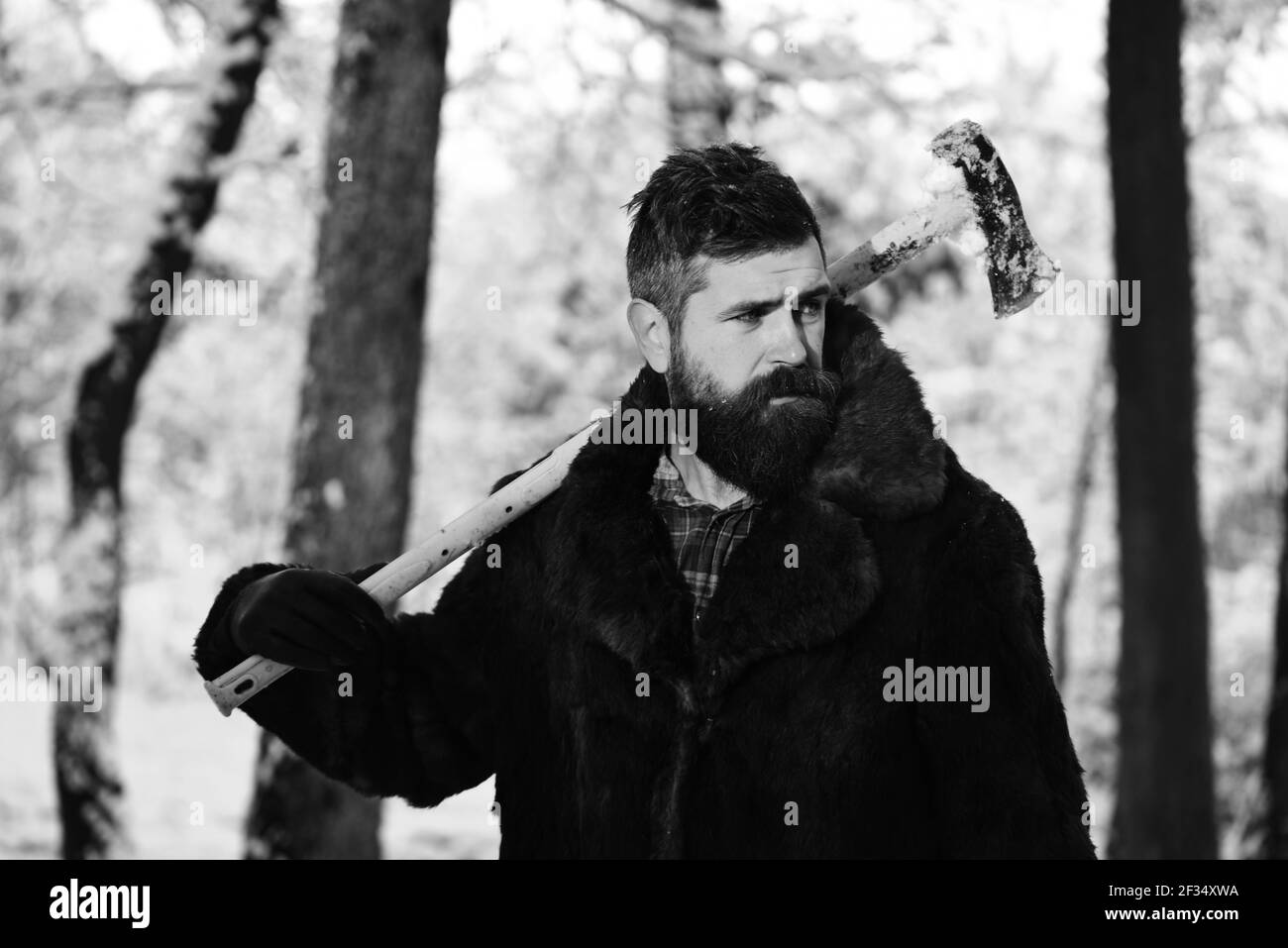 Macho with beard and mustache holds yellow ax Stock Photo - Alamy