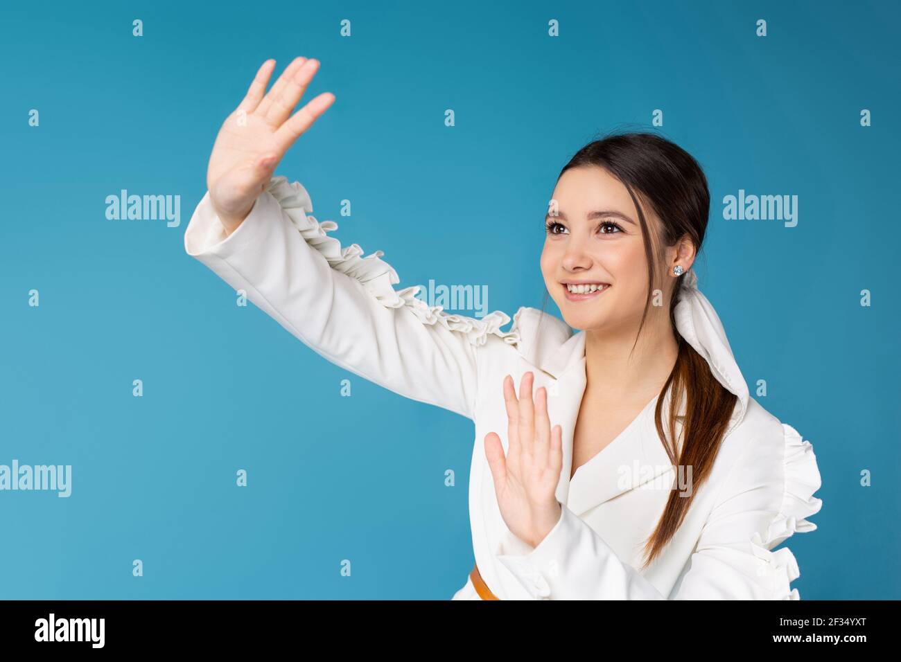 Young attractive girl businesswoman on a blue background is covered ...