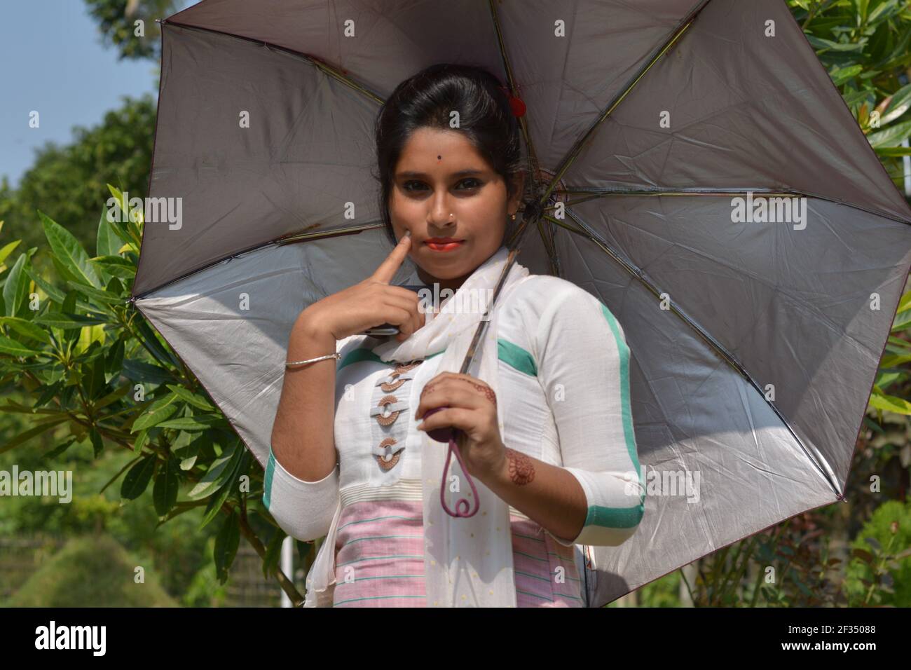 Close up of an Indian Bengali teenage girl wearing white cotton salwar ...