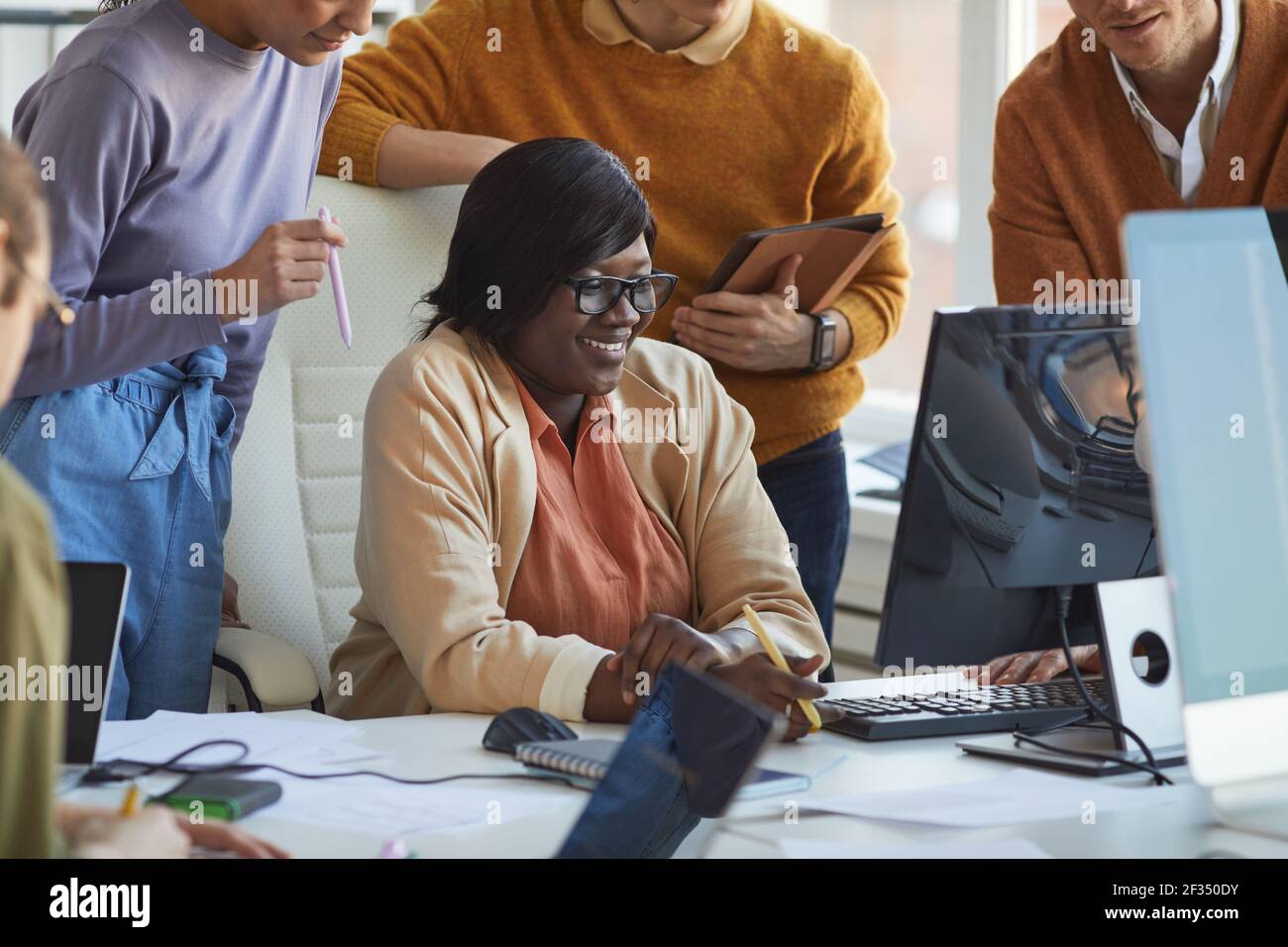 Cropped shot of diverse IT development team collaborating on project ...