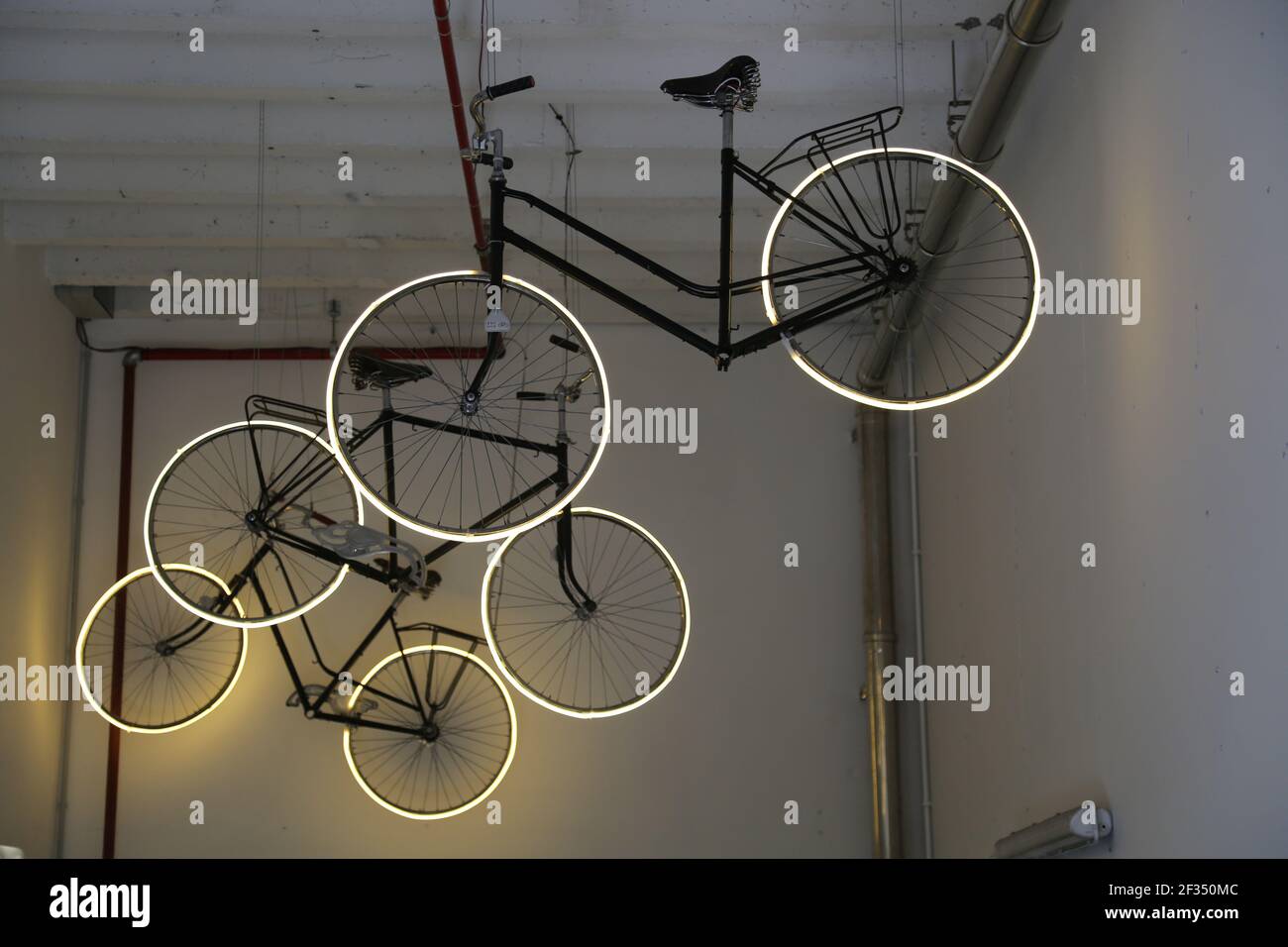 Bikes with lights hanging from ceiling Stock Photo - Alamy