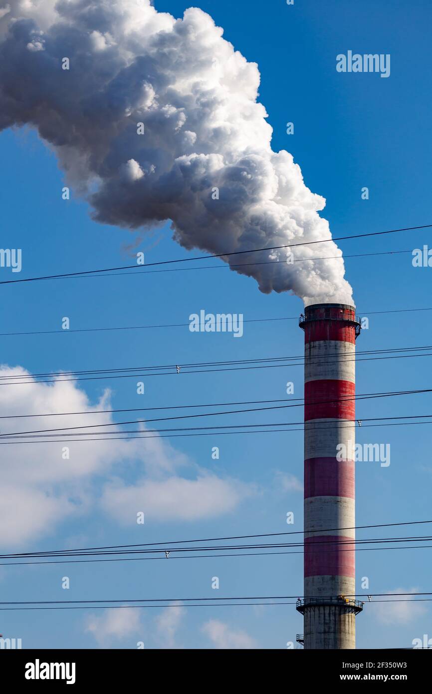 A close-up of the smoking chimneys of a coal-fired power plant. Made in ...
