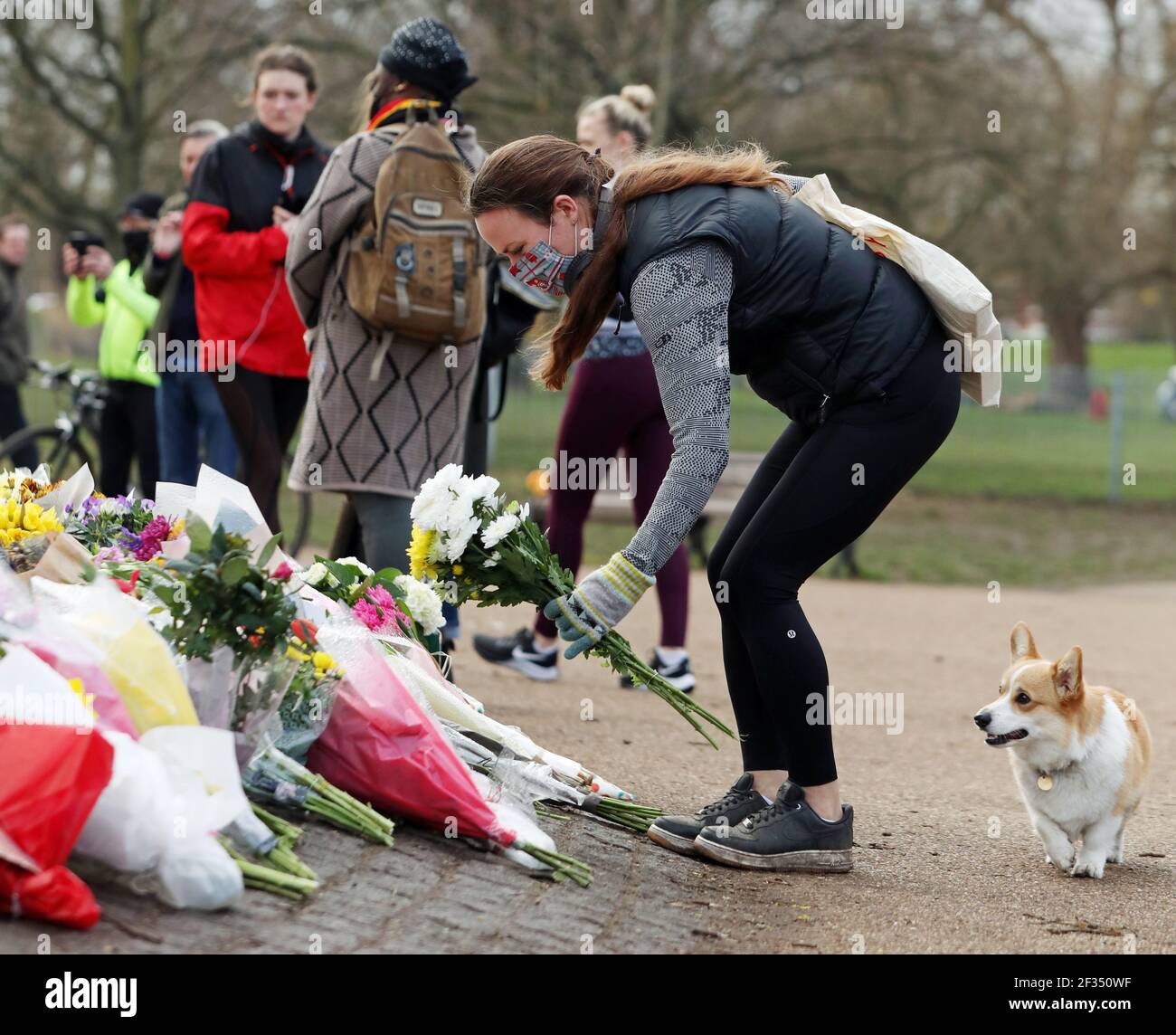 A person lays flowers for murdered Sarah Everard at the band stand in ...
