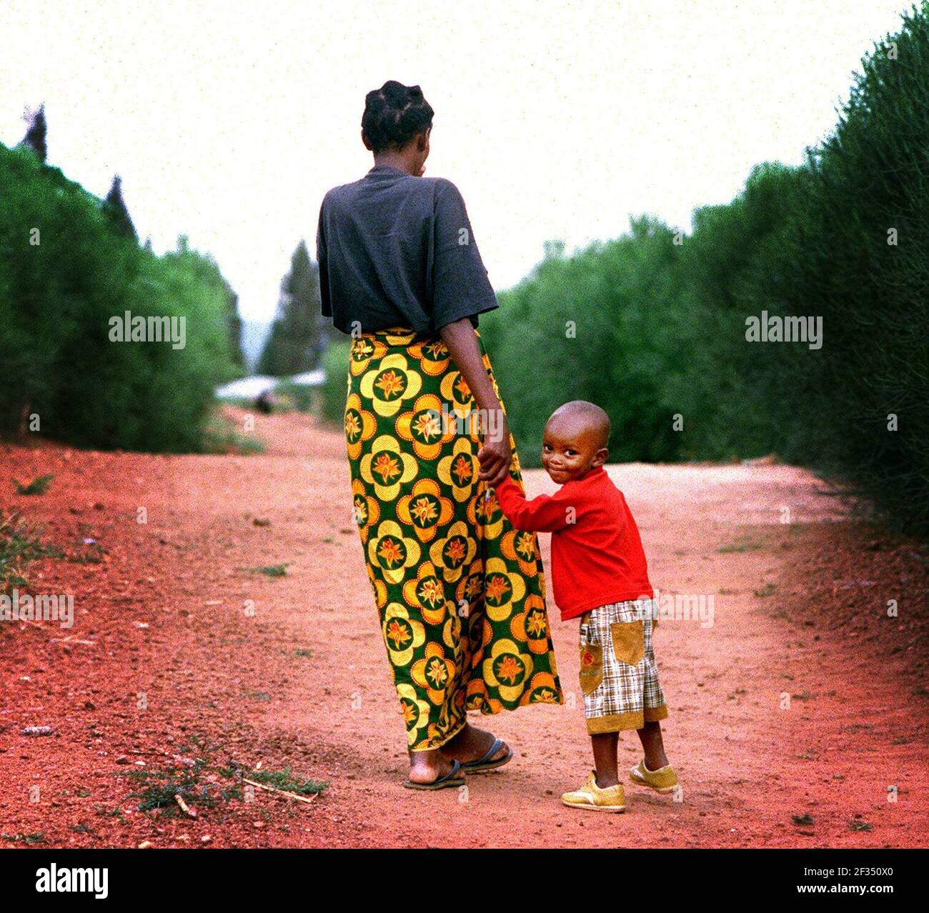 Tutsi woman with her son in Rwanda February 1999 born after she was ...