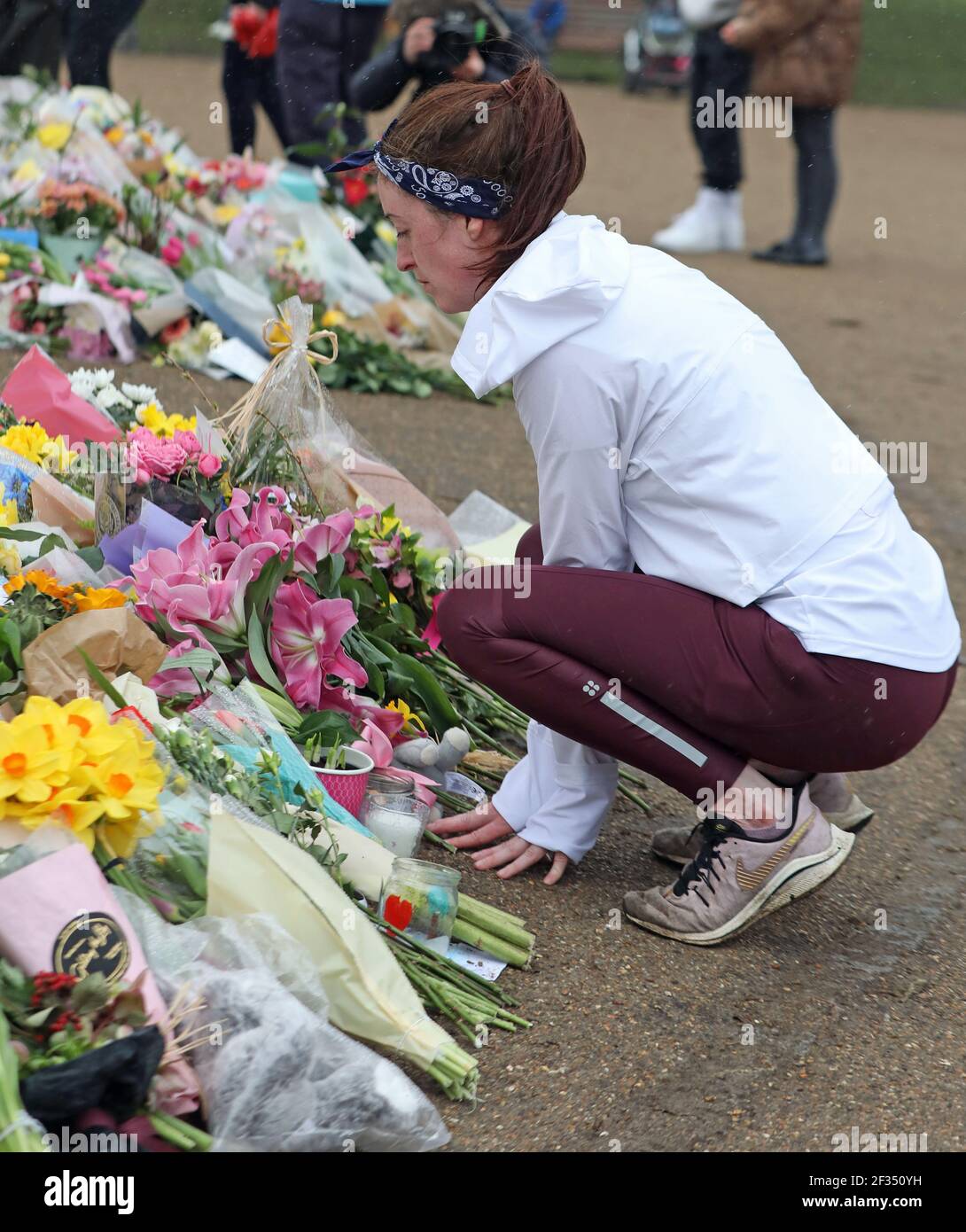 A person lays flowers for murdered Sarah Everard at the band stand in ...