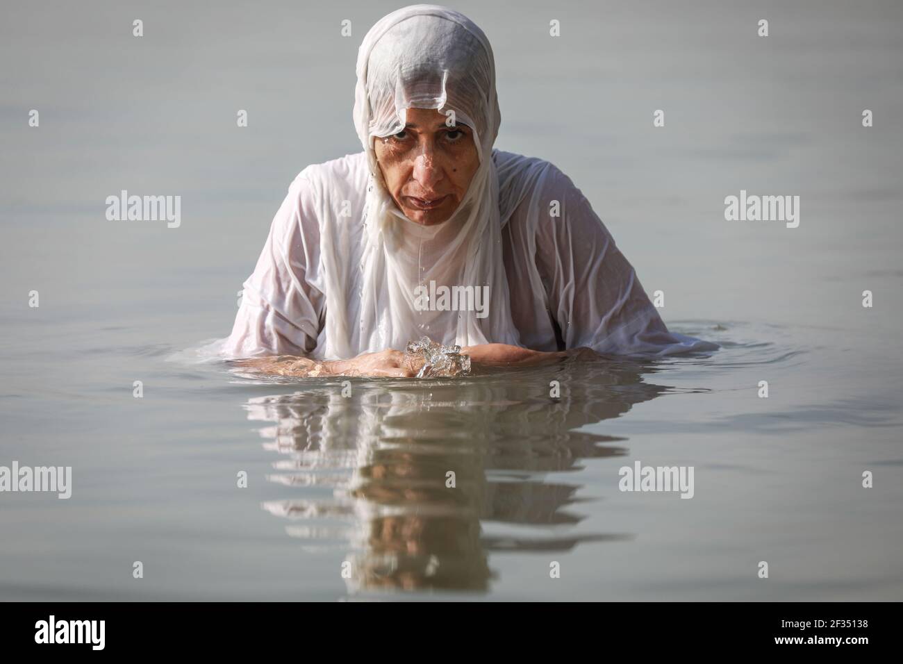 Baghdad, Iraq. 15th Mar, 2021. A Mandaean woman takes part in a baptism ...