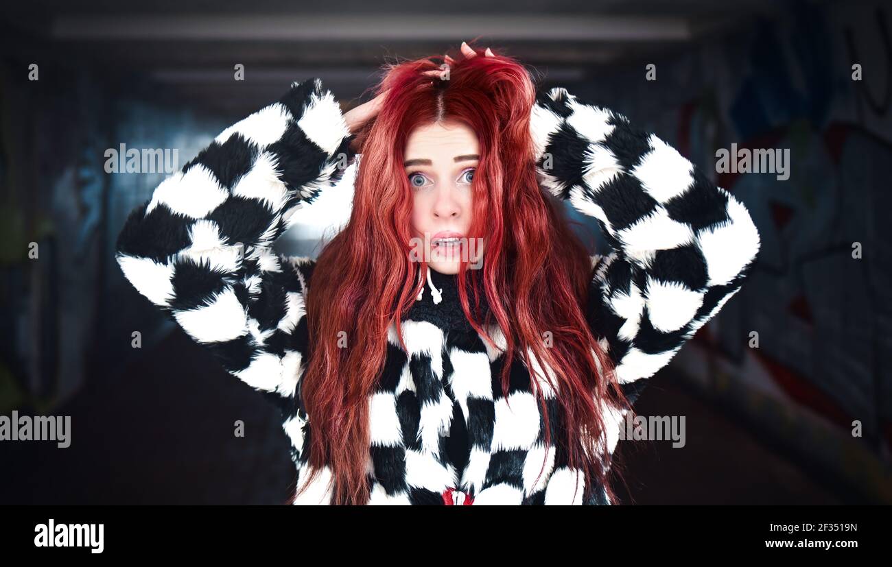 Concepts Against Violence. A very scared Girl with red hair stands near ...