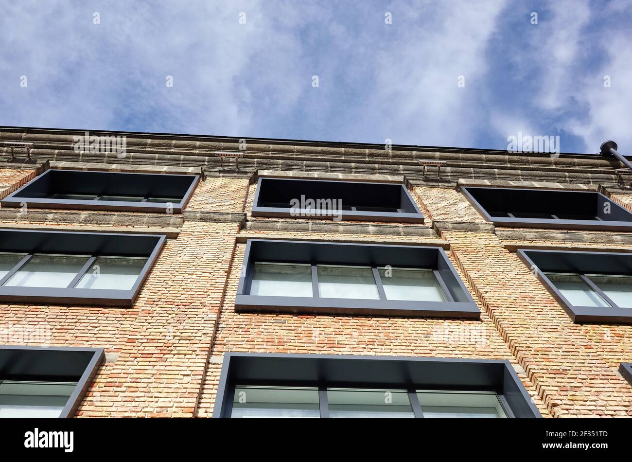 Facade of old factory building. Brick building with windows and ...