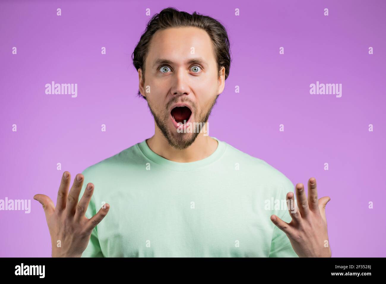 Man depicts amazement, shows WOW delight face effect. Surprised excited ...