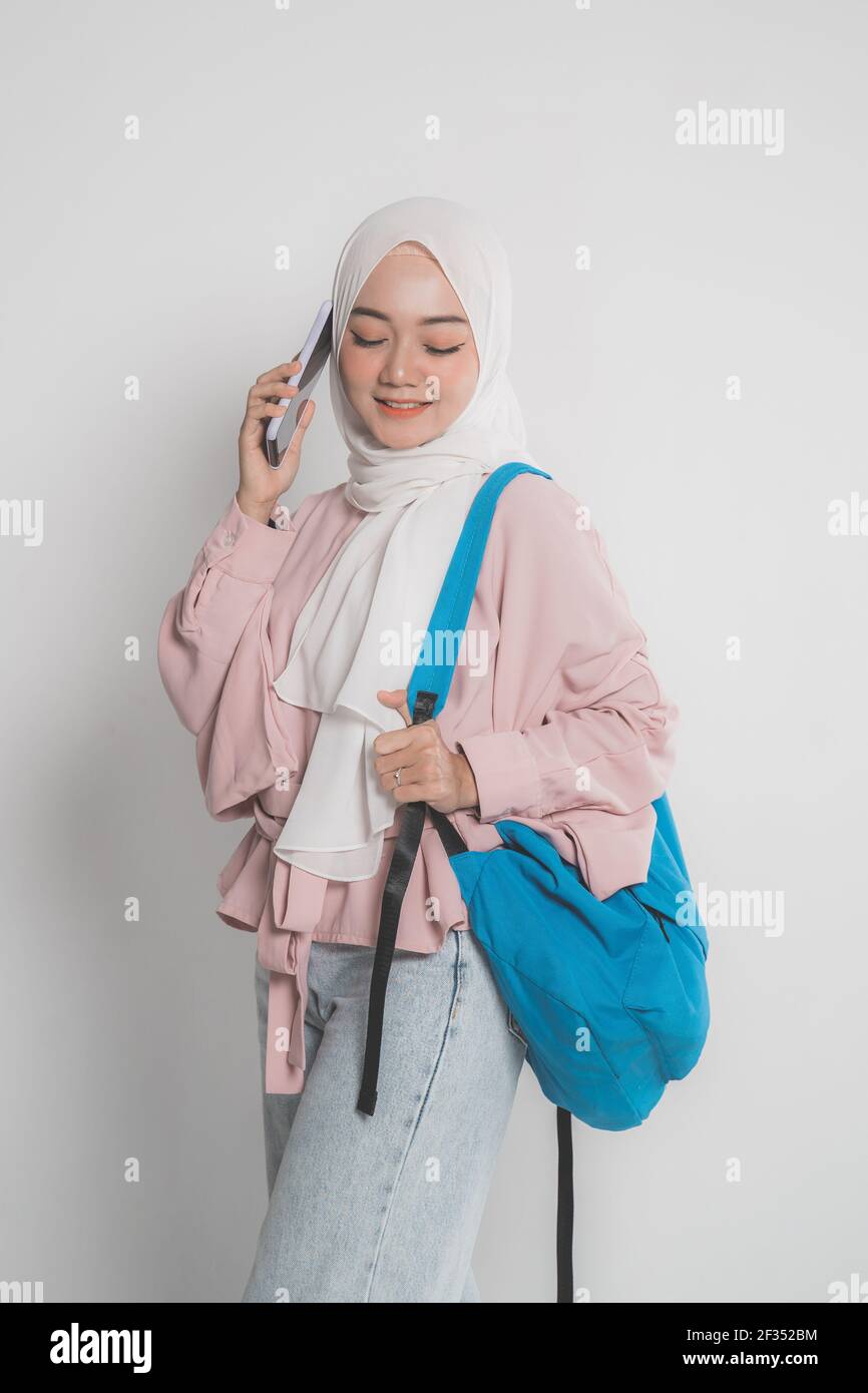 attractive young muslim student using mobile phone Stock Photo - Alamy