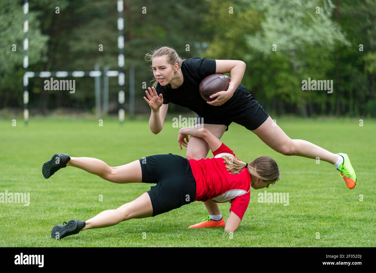 Girls playing rugby together outside in summer. Woman sport concept ...
