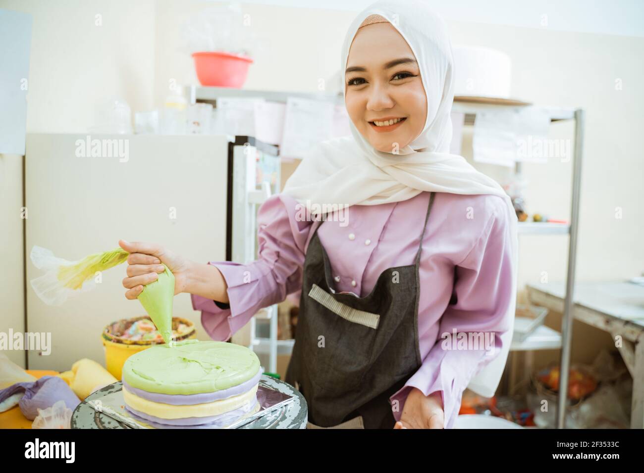 beautiful young baker making cake at her kitchen Stock Photo - Alamy