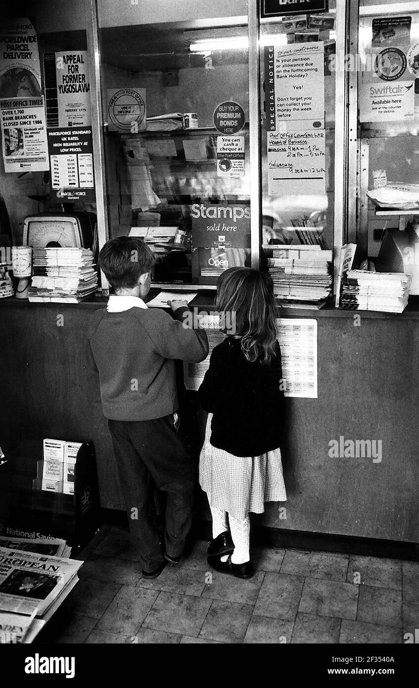 Post Office counter with children making a transaction ovr the counter ...