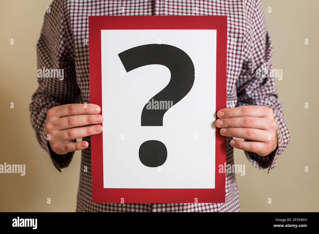 Man holding paper with question mark Stock Photo - Alamy