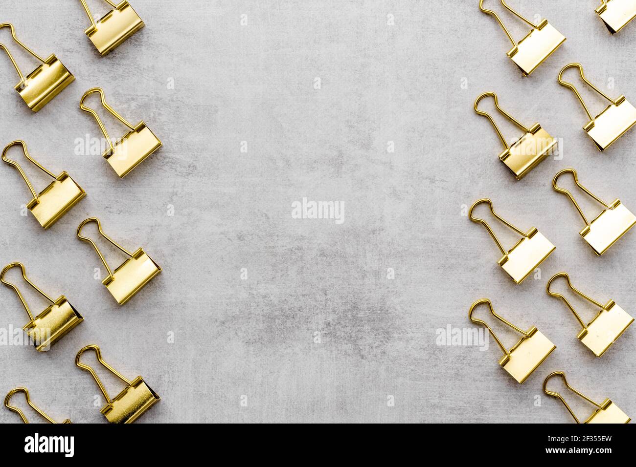 Frame of stationery golden paper binder clips top view. Office supplies ...