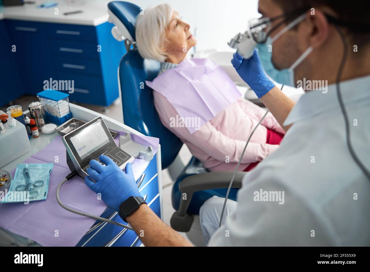 Female dentist using dental drill hi-res stock photography and images ...