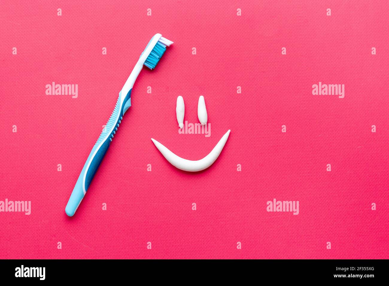 Smile shape of toothpaste with toothbrush, top view. Oral care and ...