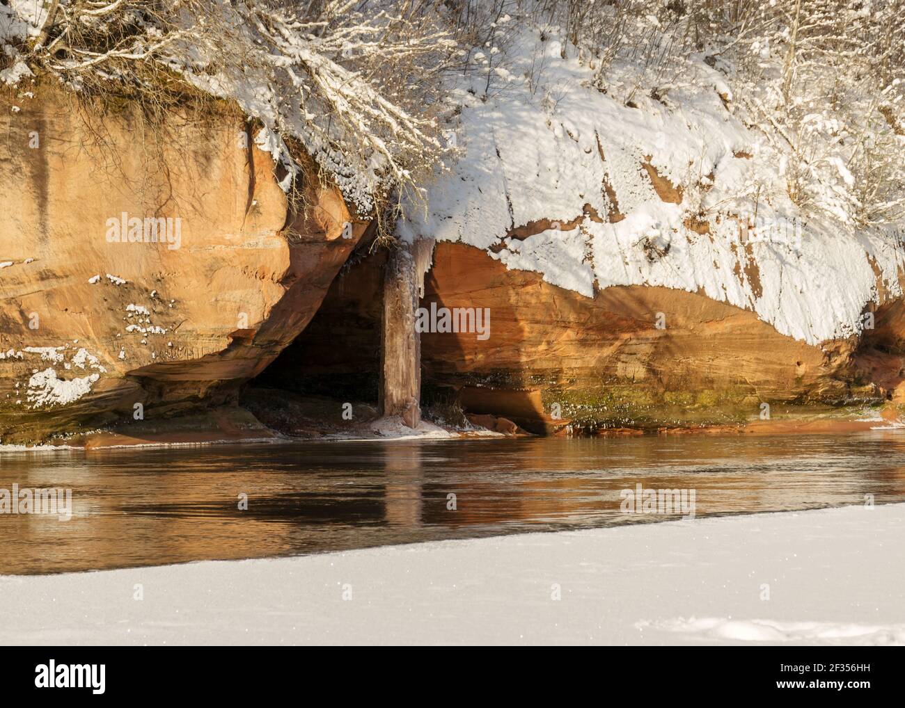 beautiful sunny day, landscape with red sandstone cliffs that are snowy ...