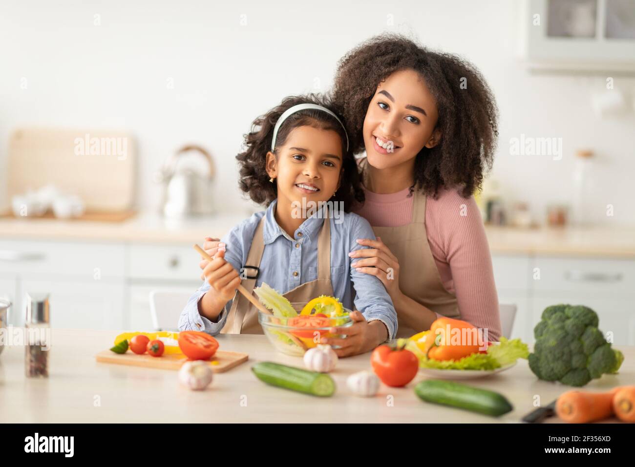 African american mother and daughter cooking tasty salad Stock Photo ...