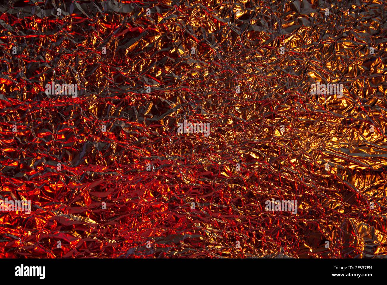 Abstract golden red aluminum wrinkled foil background texture ...