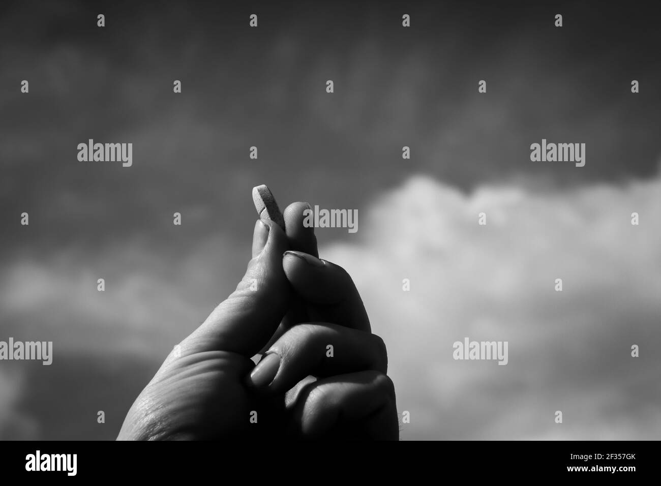 A pill held in a hand in a hand, a symbol of addiction or hope Stock ...