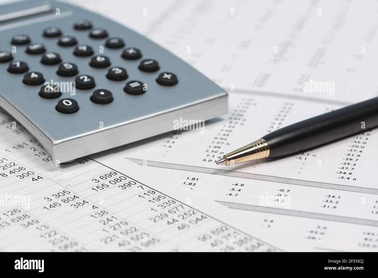 Financial accounting Pen and calculator on balance sheets Stock Photo ...