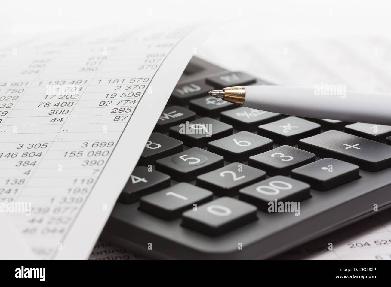 Financial accounting Pen and calculator on balance sheets Stock Photo ...
